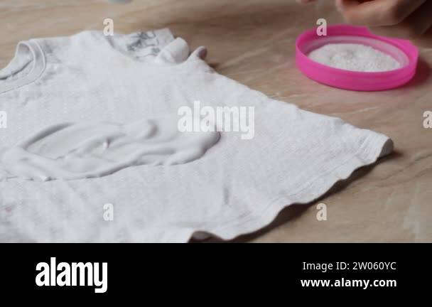 Mother to clean stains on childrens clothes from candies with the help ...
