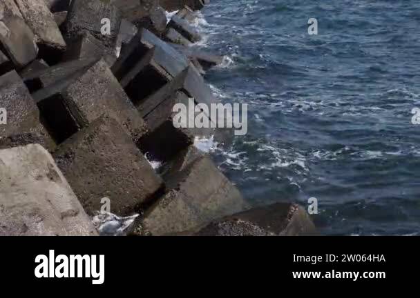 Destroyed coastal concrete protective structure. Large deep cracks ...