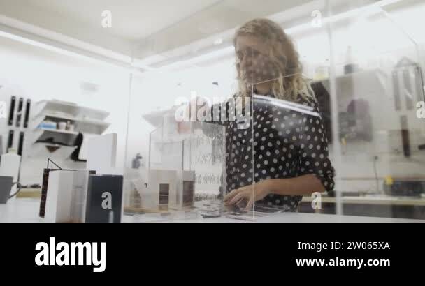 People at work in architecture design studio with plastic model and ...