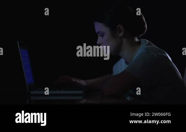 Teenager girl crying because of problems with laptop, sitting in dark ...