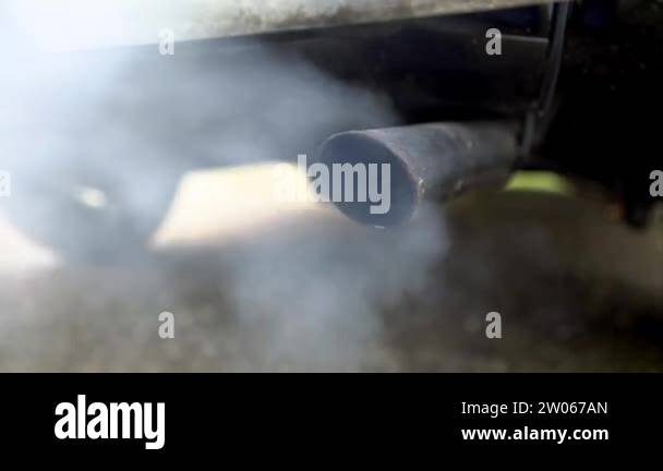 4K, Close-up combustion fumes coming out of car exhaust pipe which ...