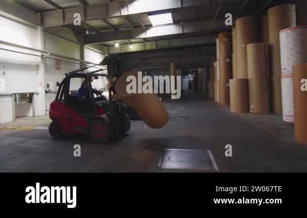 forklift loader carries paper roll to railway in warehouse Stock Video ...