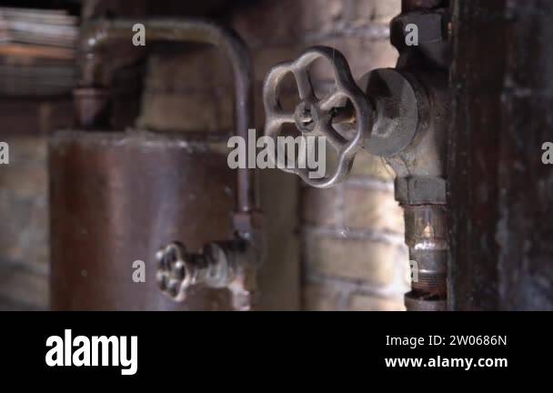Rusty boiler room pipes. Old metal boiler generating heating and ...