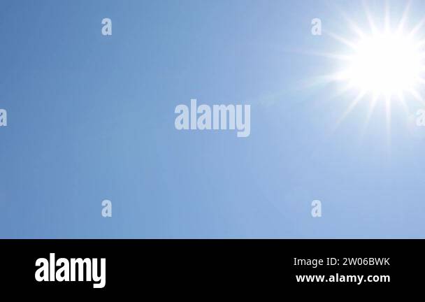 Sun traveling across clear blue sky, hot sunny day, looking into the ...