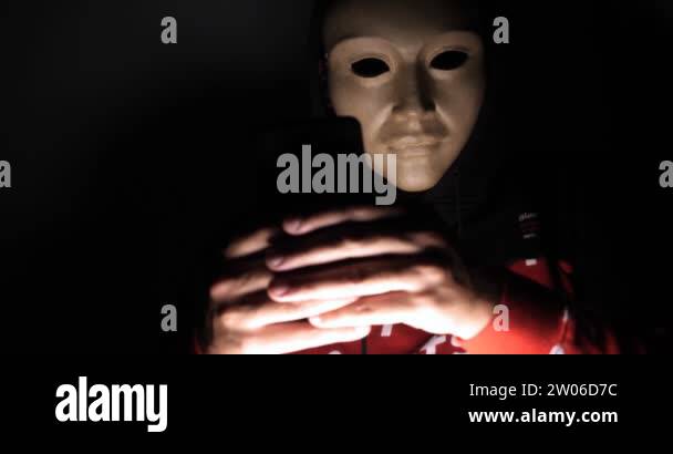 Male hacker hidden face with the mask accessing to personal information ...