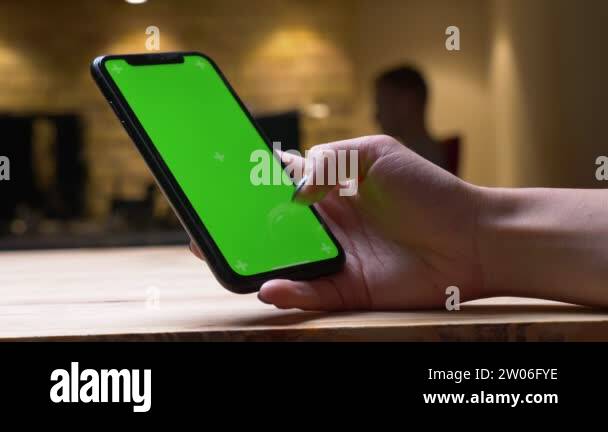 Closeup back view shoot of female hand scrolling on the phone with ...