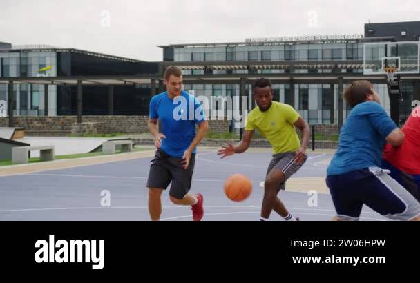 Front view of Multi-ethnic basketball players playing basketball in ...
