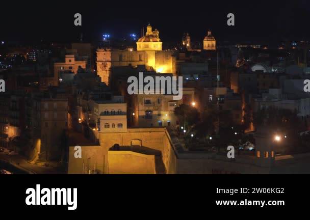 Panoramic night view of a coast line and the downtown of Valletta ...