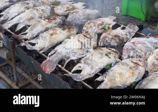 Close up shot how fish with salt is frieding on a barbecue Stock Video ...
