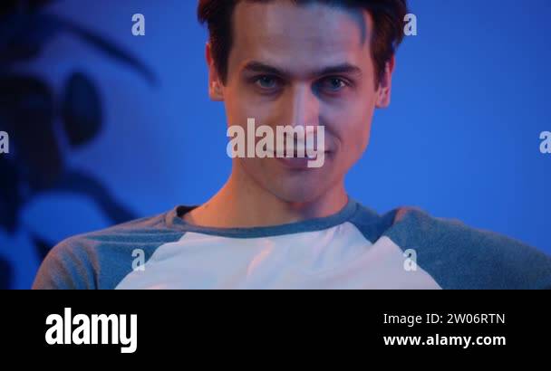 Handsome young guy looking and posing to camera. Close up view of cute ...