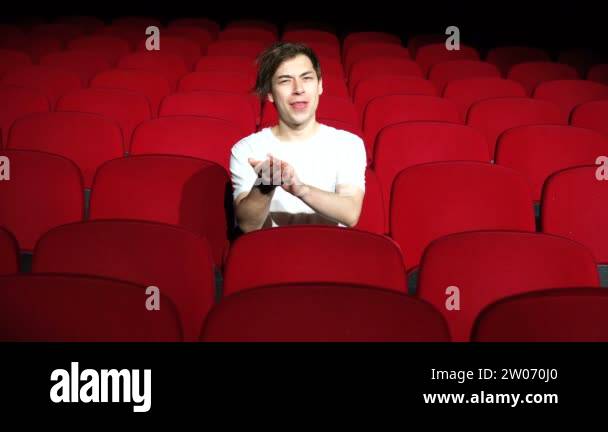 man sitting alone and clapping in empty cinema hall or theater Stock ...