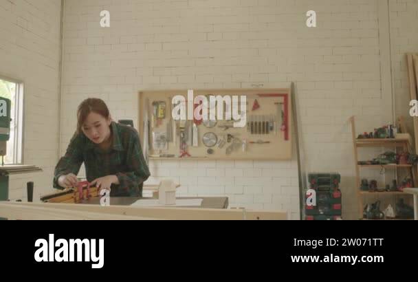 Two carpenter teamwork male and female reading blueprint building design project to customer ...