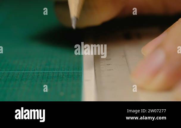 Close-up of male architect hands drawing mark on white paperboard with ...