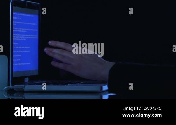 Hands stop typing when blue screen on laptop appears, virus in ...