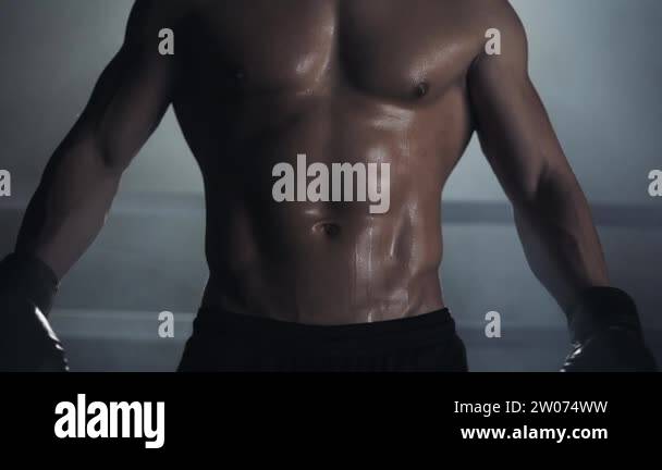 A male boxer shows a press and muscles. Close up. Boxing ring ...