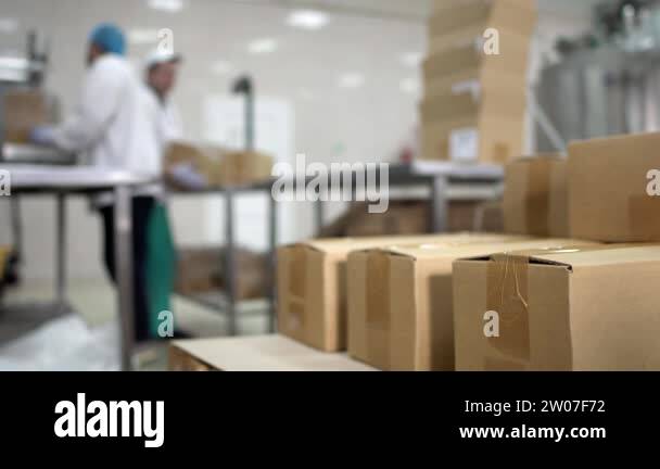 Boxes with finished dairy products at the factory on the background of ...