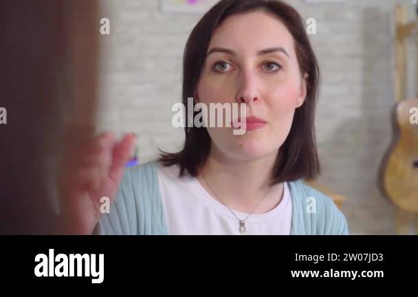 close-up face beautiful deaf young women uses sign language in the ...