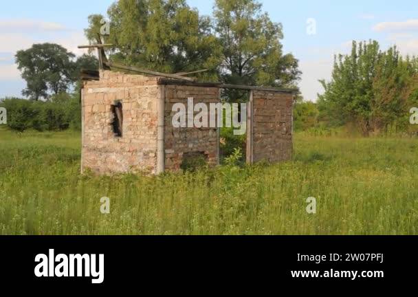 Ruined house in the middle of the field. Abandoned house overgrown with ...