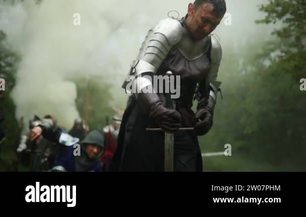 Combat squad of medieval knights of the Crusaders stand in armors and ...