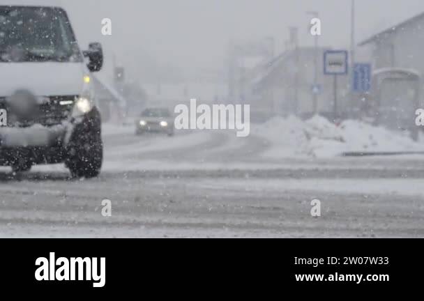 SLOW MOTION, DOF: City traffic drives through a intersection in the ...