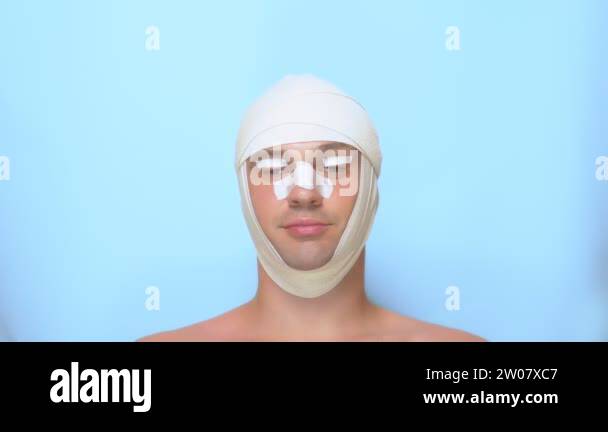 a man after a plastic surgery facelift, rhinoplasty, blepharoplasty. with a bandage on the nose ...