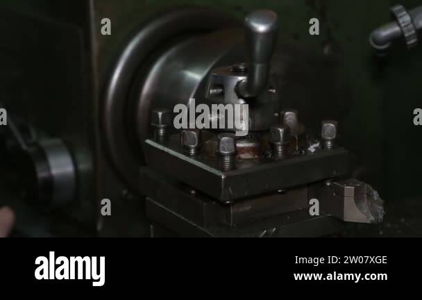 Lathe in action. Old lathe in the lathe shop.The operator of the ...