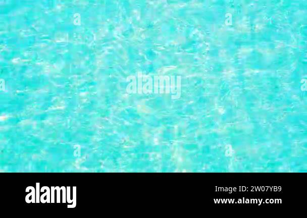 light blue on water in sea surface and light reflections and wave surge ...
