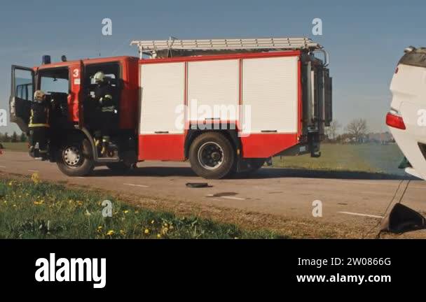 Rescue Team of Firefighters Arrive on the Car Crash Traffic Accident ...