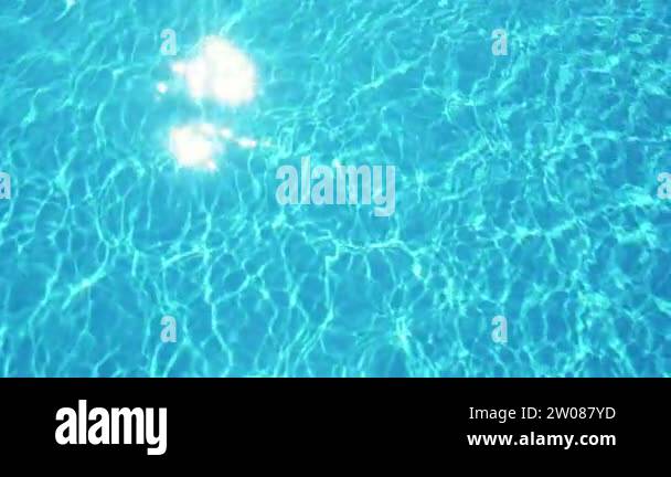 Celeste waves with playful spots waving in a swimming pool in slo-mo ...