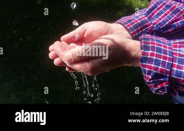 Water pouring on man hand slow motion. Hands washing in crystal clean ...
