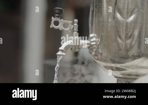 Boiling water running down from a large metal samovar - water stream ...