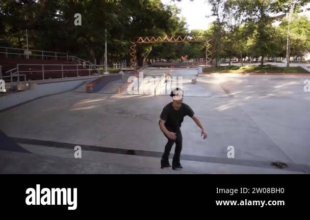 Determinated young man running on inline roller skates at ramp in ...