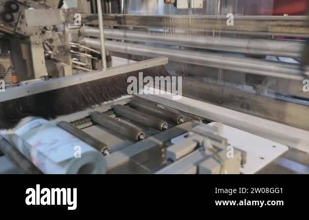 A roll of wallpaper on a conveyor line. Roll of wallpaper. Conveyor ...