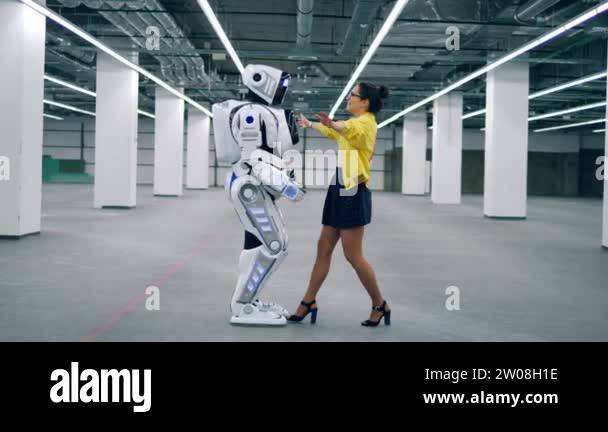 Robot and woman hugging each other, standing in an empty room Stock ...