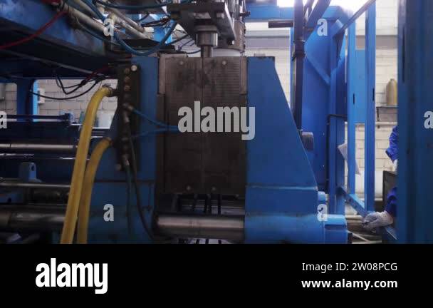 The process of blowing plastic tanks in extrusion equipment. Molten ...