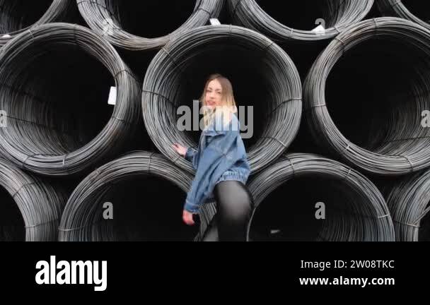 Girl posing in the seaport near a metal cable, dressed in legends and ...