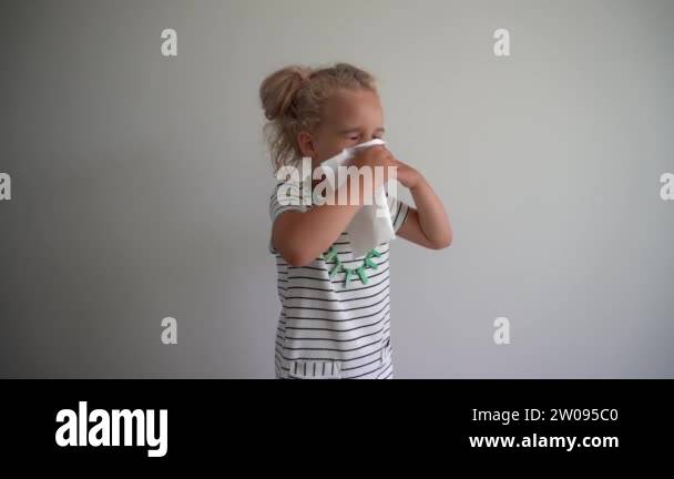 Little girl blow nose and get snotty face. Mother helping daughter ...