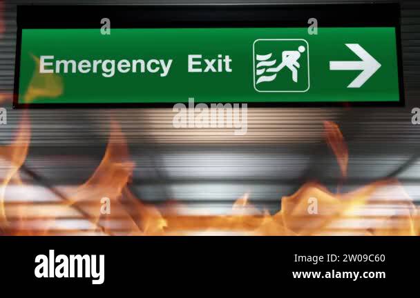 emergency exit sign with light hanging from ceiling in the building ...