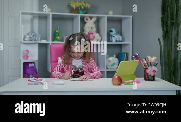 Preschool girl watching lesson online and studying from home. Kid girl ...