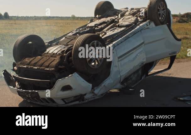 Horrific Traffic Accident Rollover Smoking and Burning Vehicle Lying on ...