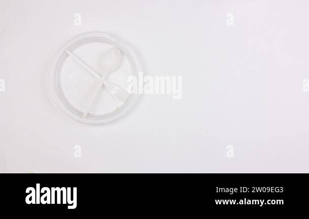 used dirty plastic disposable tableware garbage moves on white ...