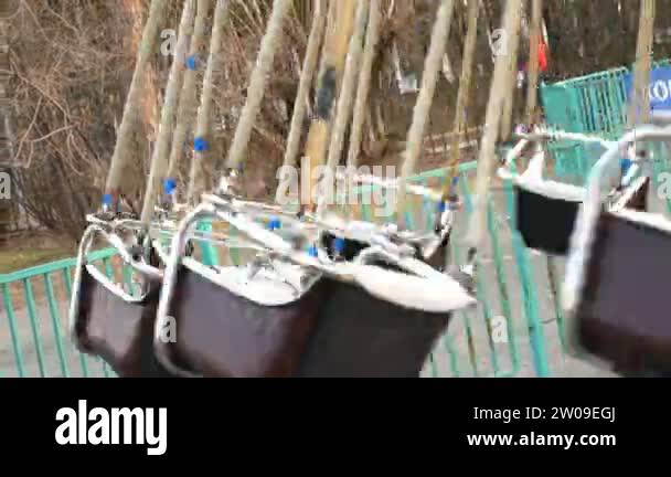 Chain carousel - attraction in the amusement park.hild rotates on chain ...