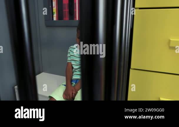 Little boy in prison in playroom Stock Video Footage - Alamy