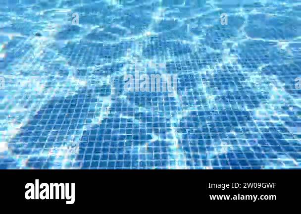 Bottom of the swimming pool. Clear water background with the reflection ...