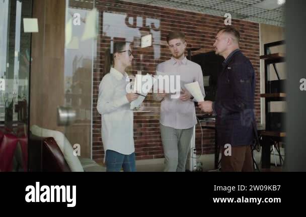 group of young businesspeople standing together in a modern office ...