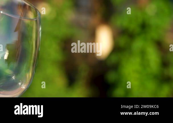 The glass transparent wine glass pours red fragrant wine. On the ...