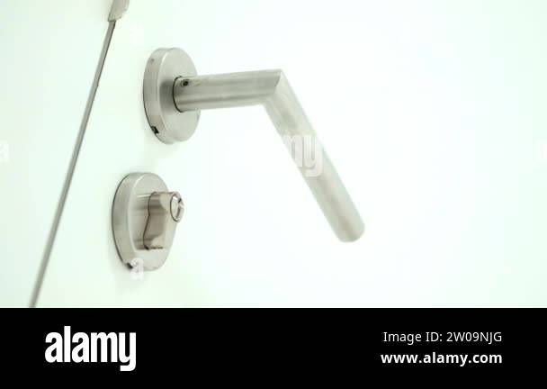A Disabled Person Without An Arm With A Prosthesis Opens The Door