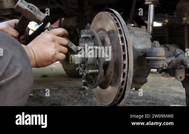 Technicians are removing the right front wheel hub of the car for ...