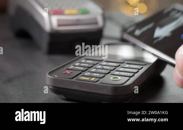 NFC Technology. The user makes contactless payment by mobile phone. Launches a smartphone to the ...