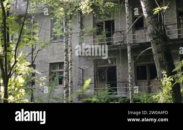 Facade old destroyed brick building with broken windows in industrial ...